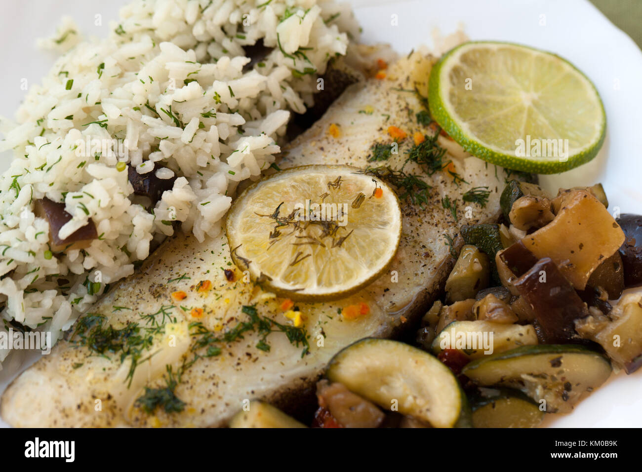 Fish with rice and eggplant Stock Photo - Alamy