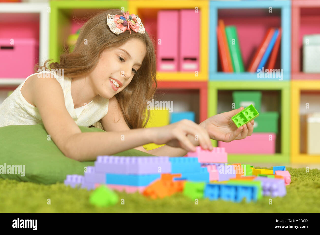 Girl playing with designer Stock Photo - Alamy