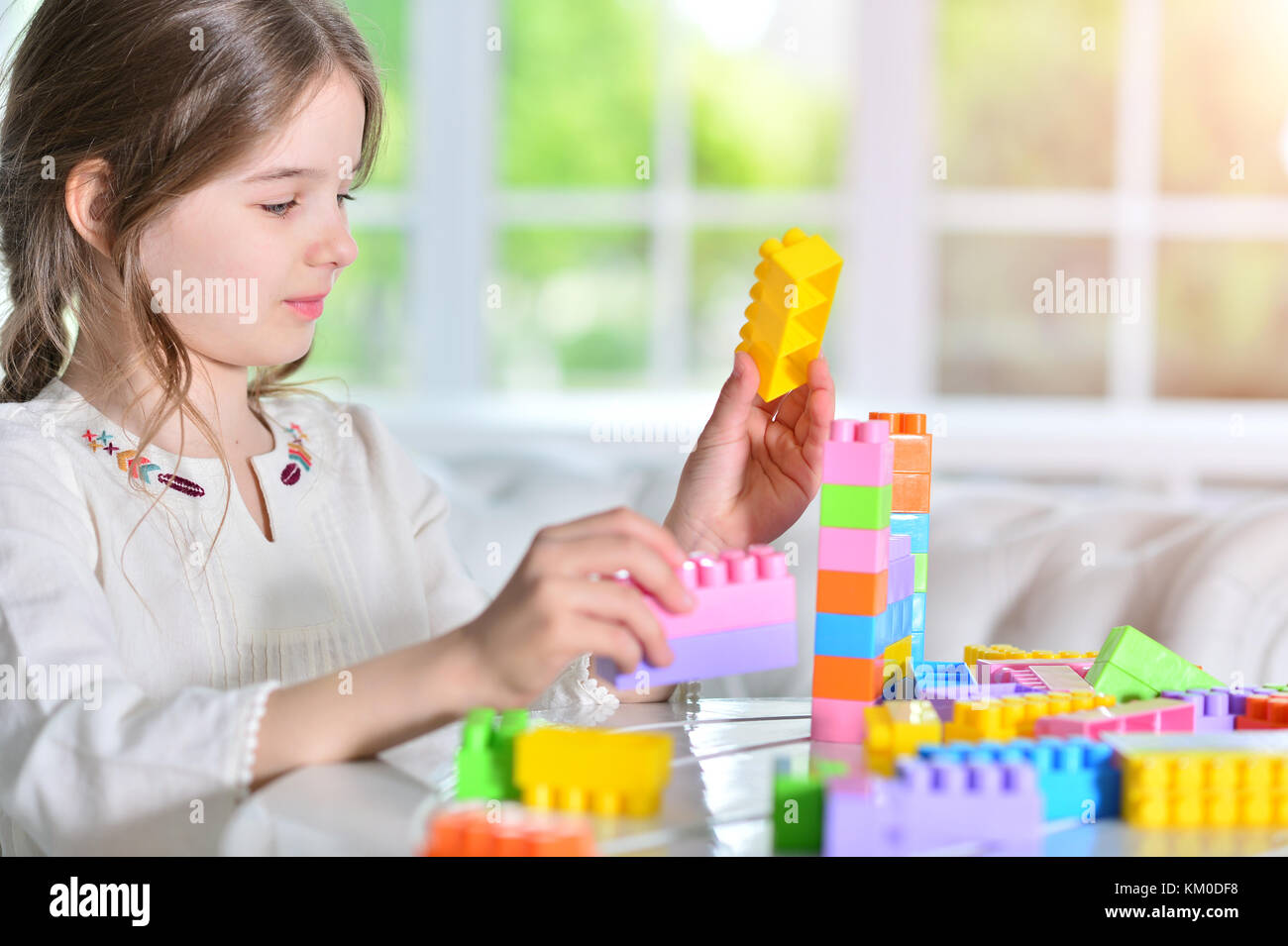Cute girl playing with blocks Stock Photo - Alamy