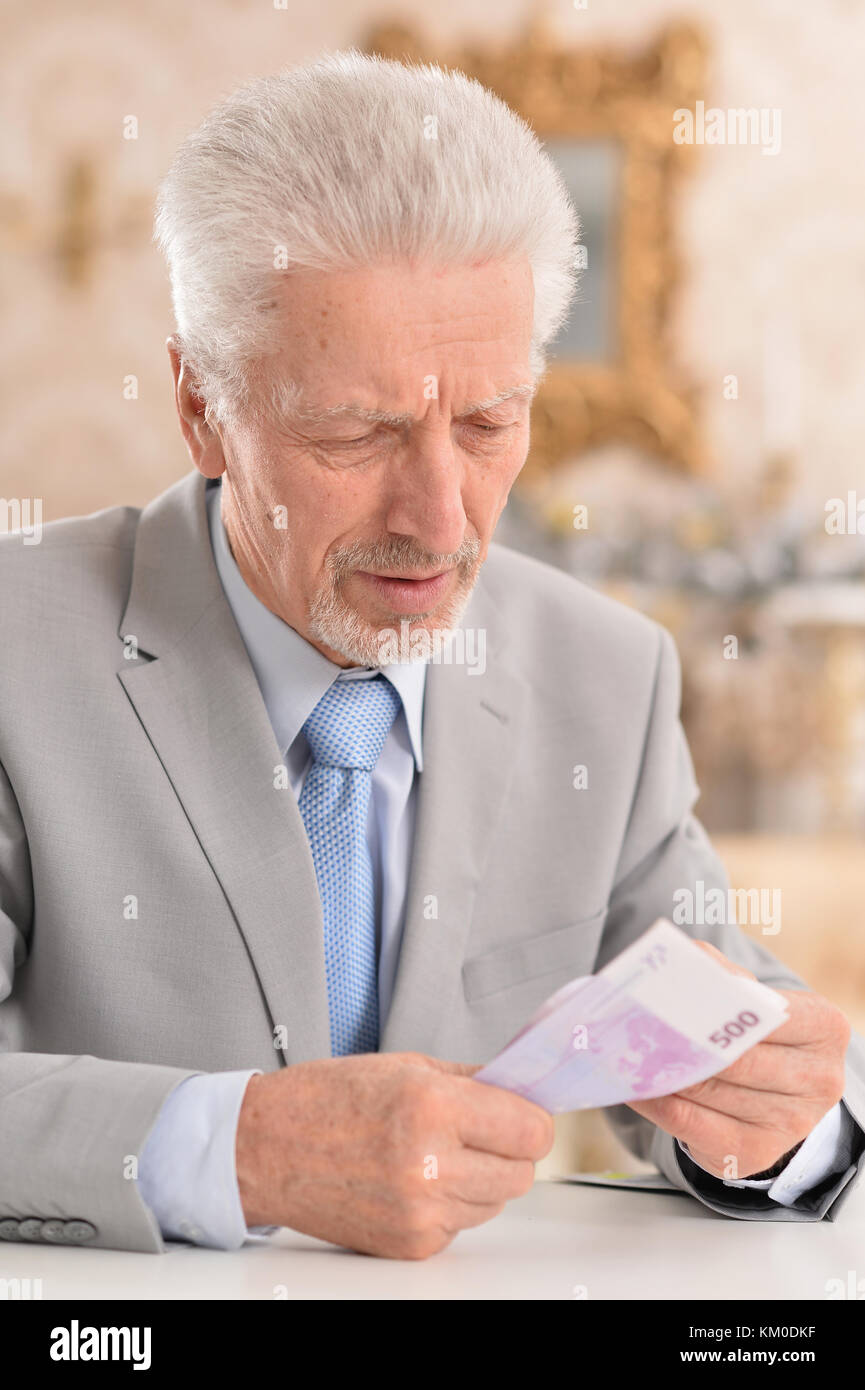 senior businessman counting money Stock Photo - Alamy