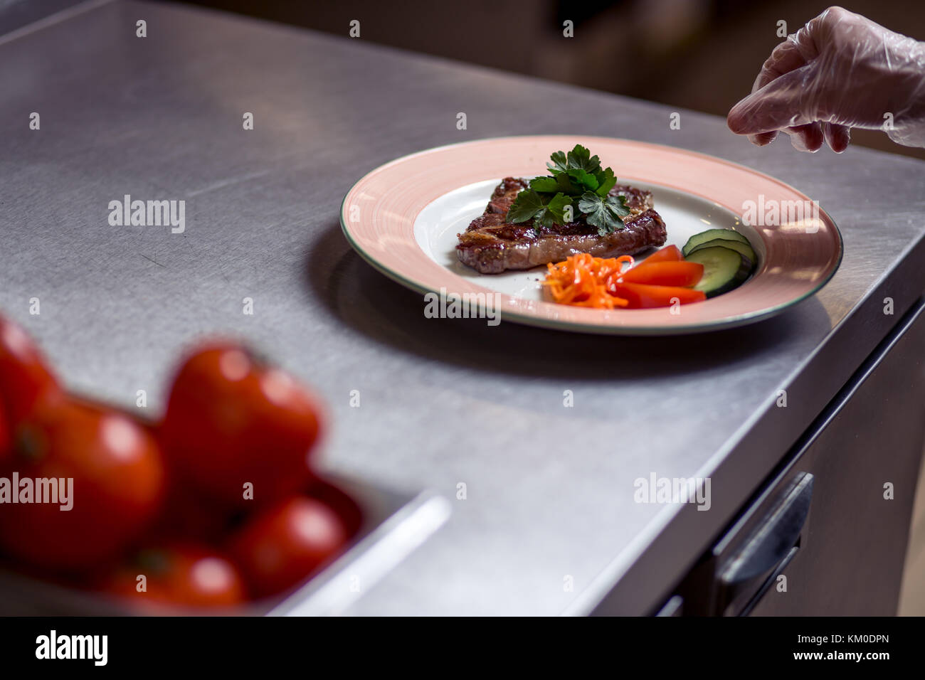 Chef finishing his plate and almost ready to serve at table Stock Photo ...