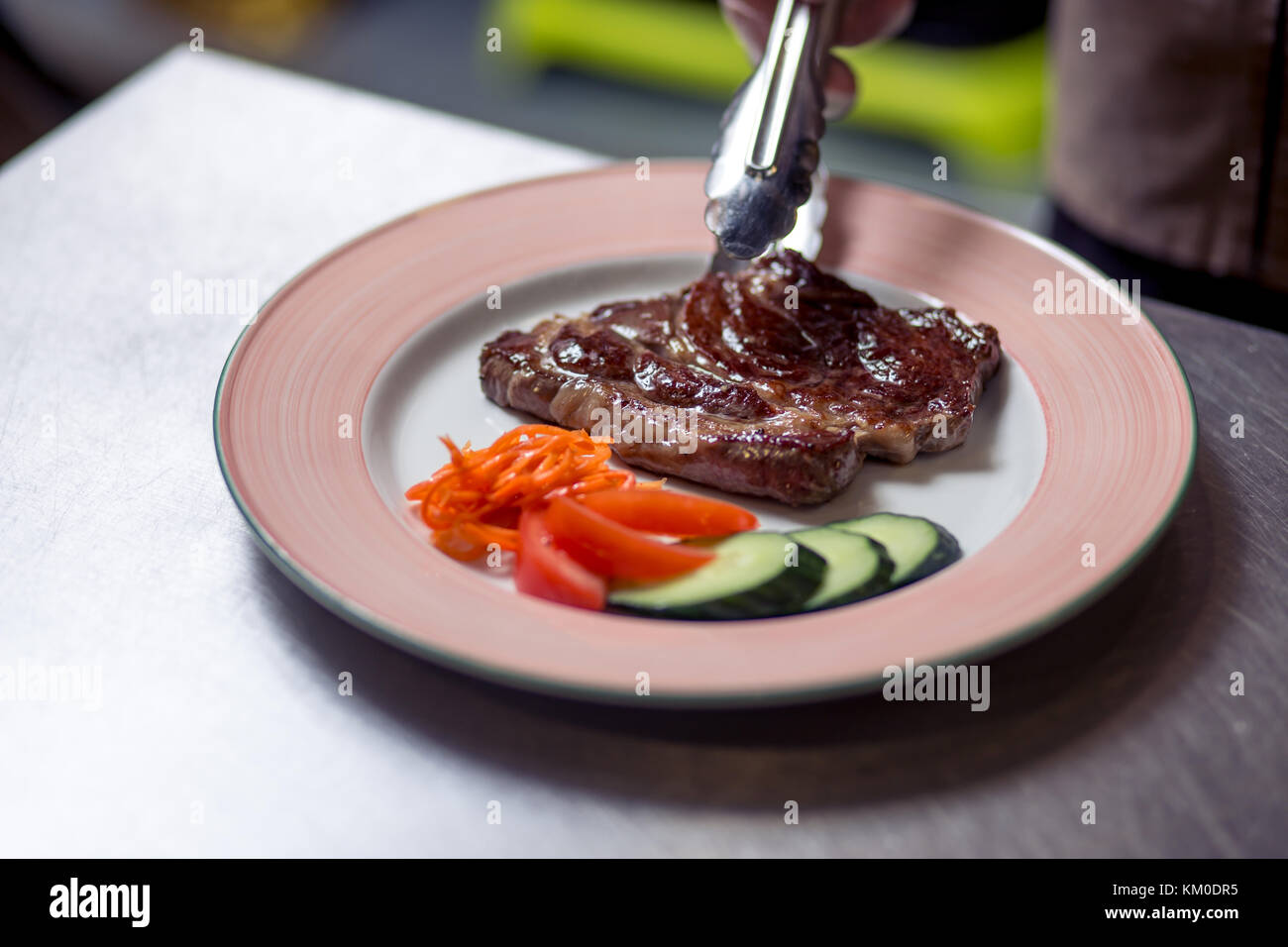 Chef finishing his plate and almost ready to serve at table Stock Photo ...