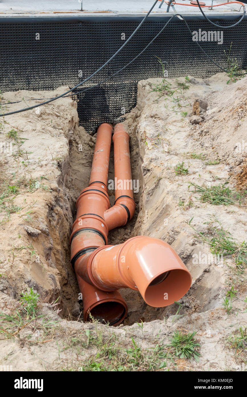 Construction site - orange waste pipe Stock Photo - Alamy