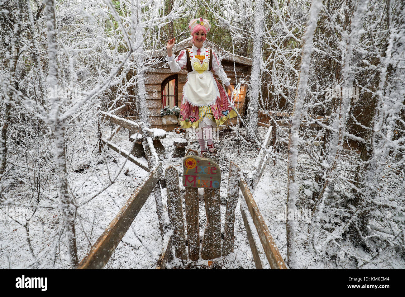 Elf Pixie Mixie makes her way through the snow covered pathway at the ...