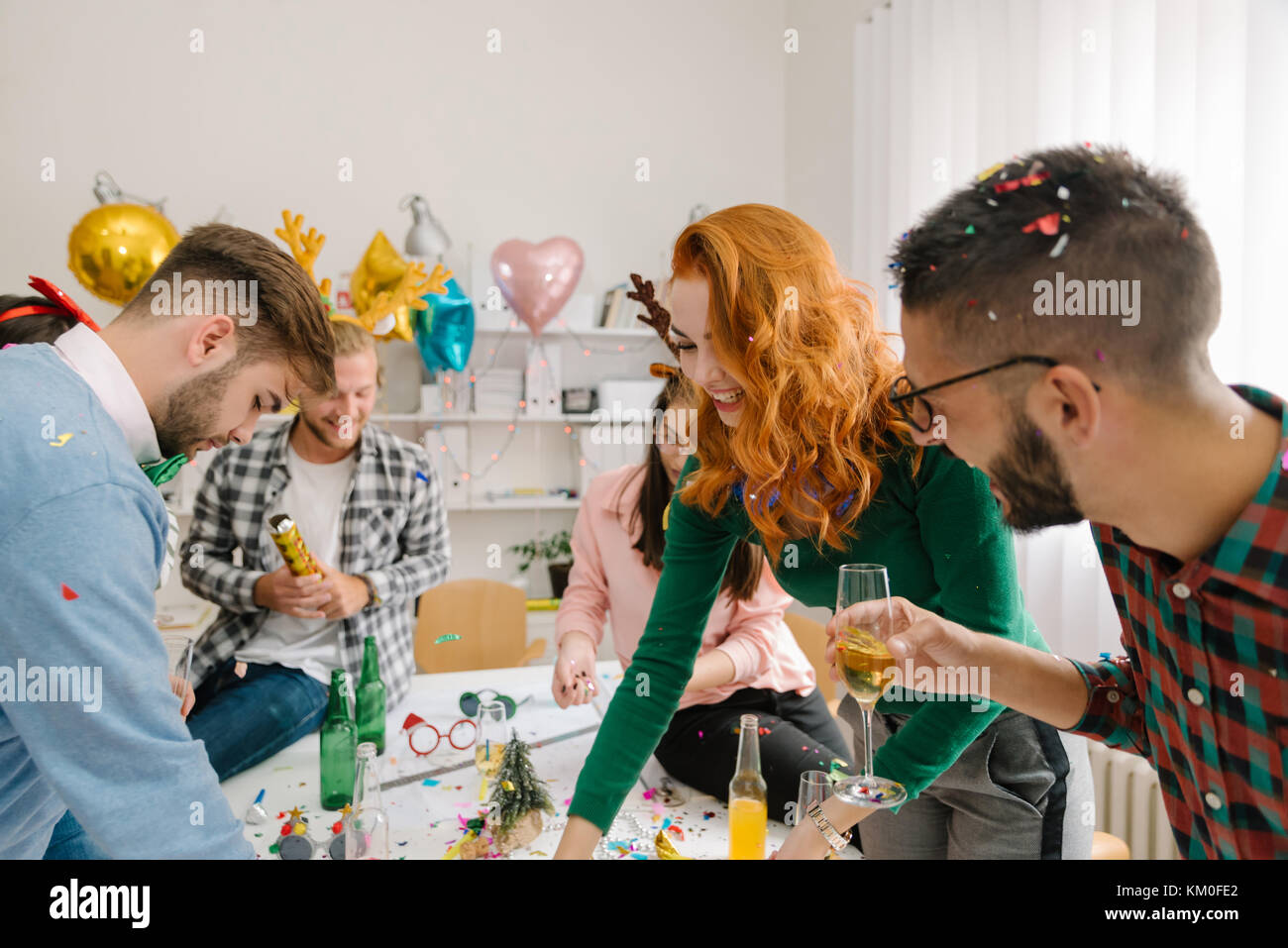 Having fun with confetti at office party Stock Photo - Alamy