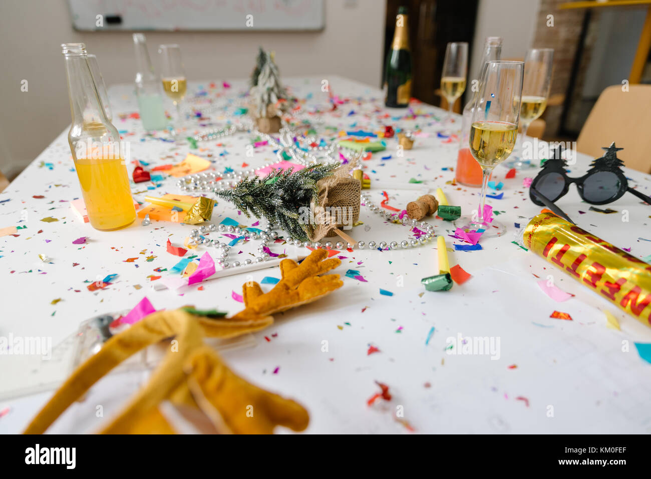 Confetti and champagne all over conference room table Stock Photo - Alamy