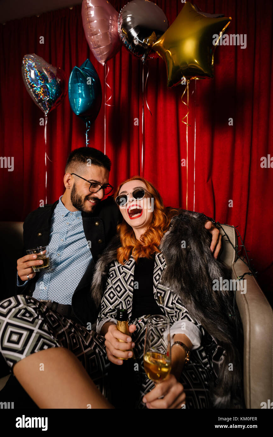 Two people hillariously smiling at a party Stock Photo - Alamy