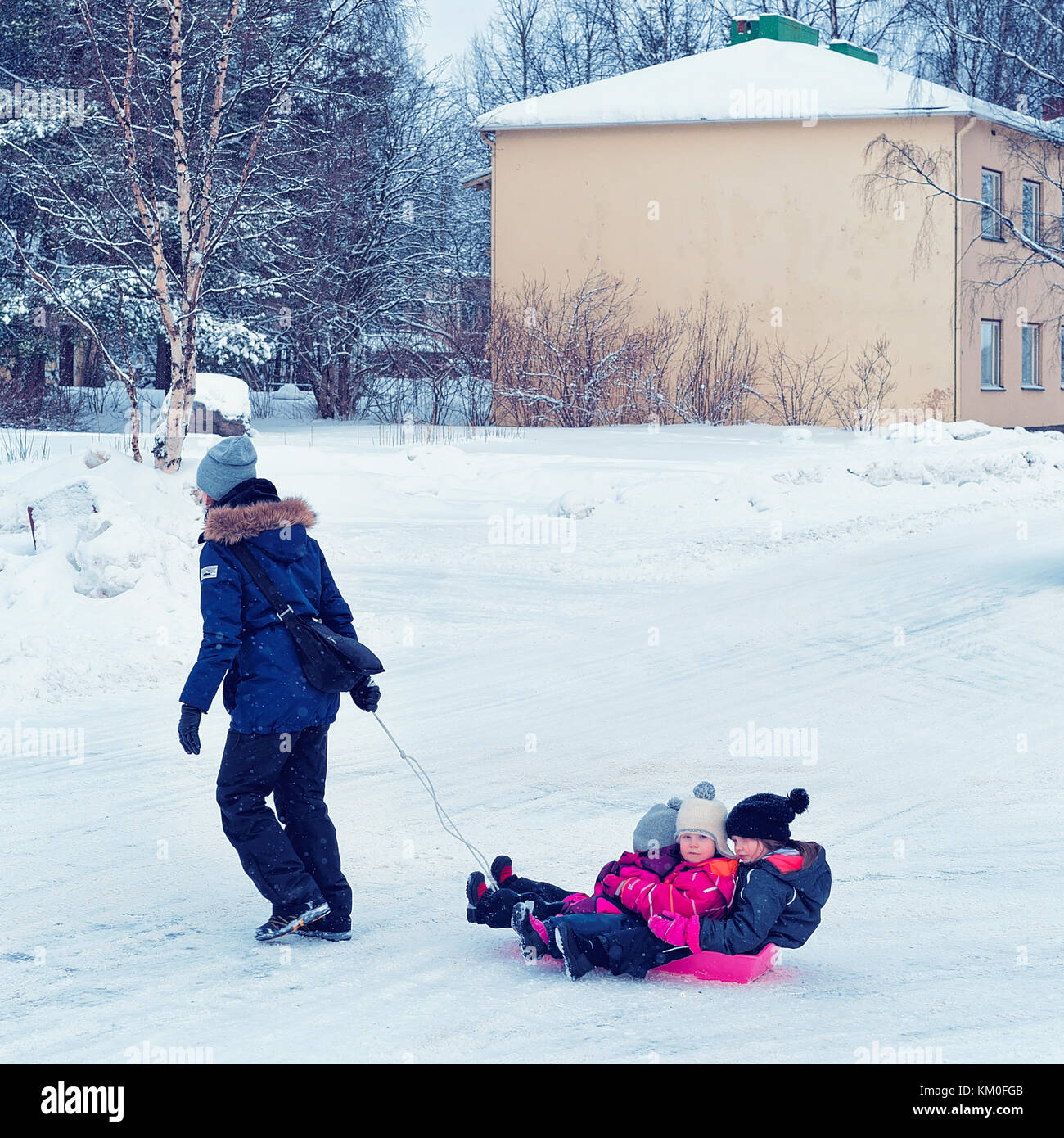 Rovaniemi, Finland - March 2, 2017: Woman with children on toboggan in ...