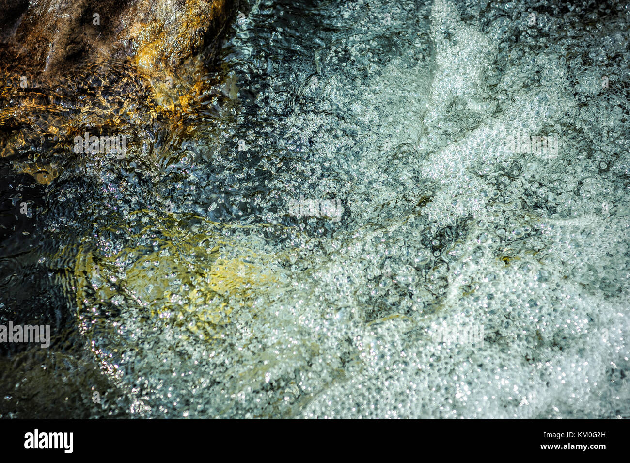 Fresh water bubbling between rocks in a mountain stream Stock Photo - Alamy