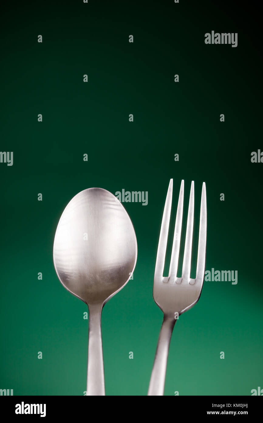 photo of a fork and a spoon in front of a colorful background Stock ...