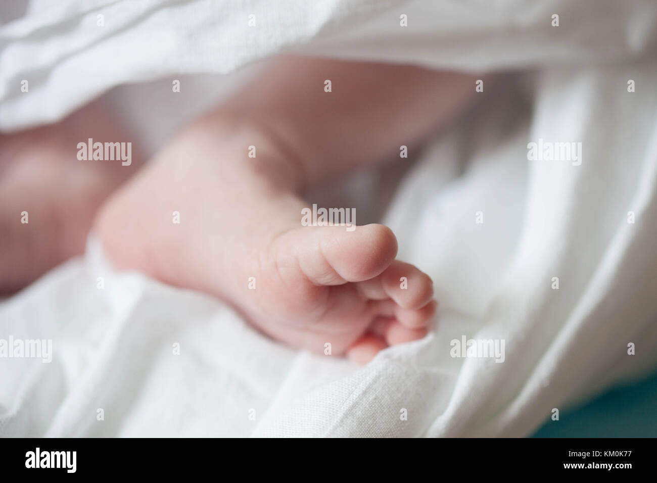 Feet of baby close up. Childish legs on blurred background Stock Photo ...