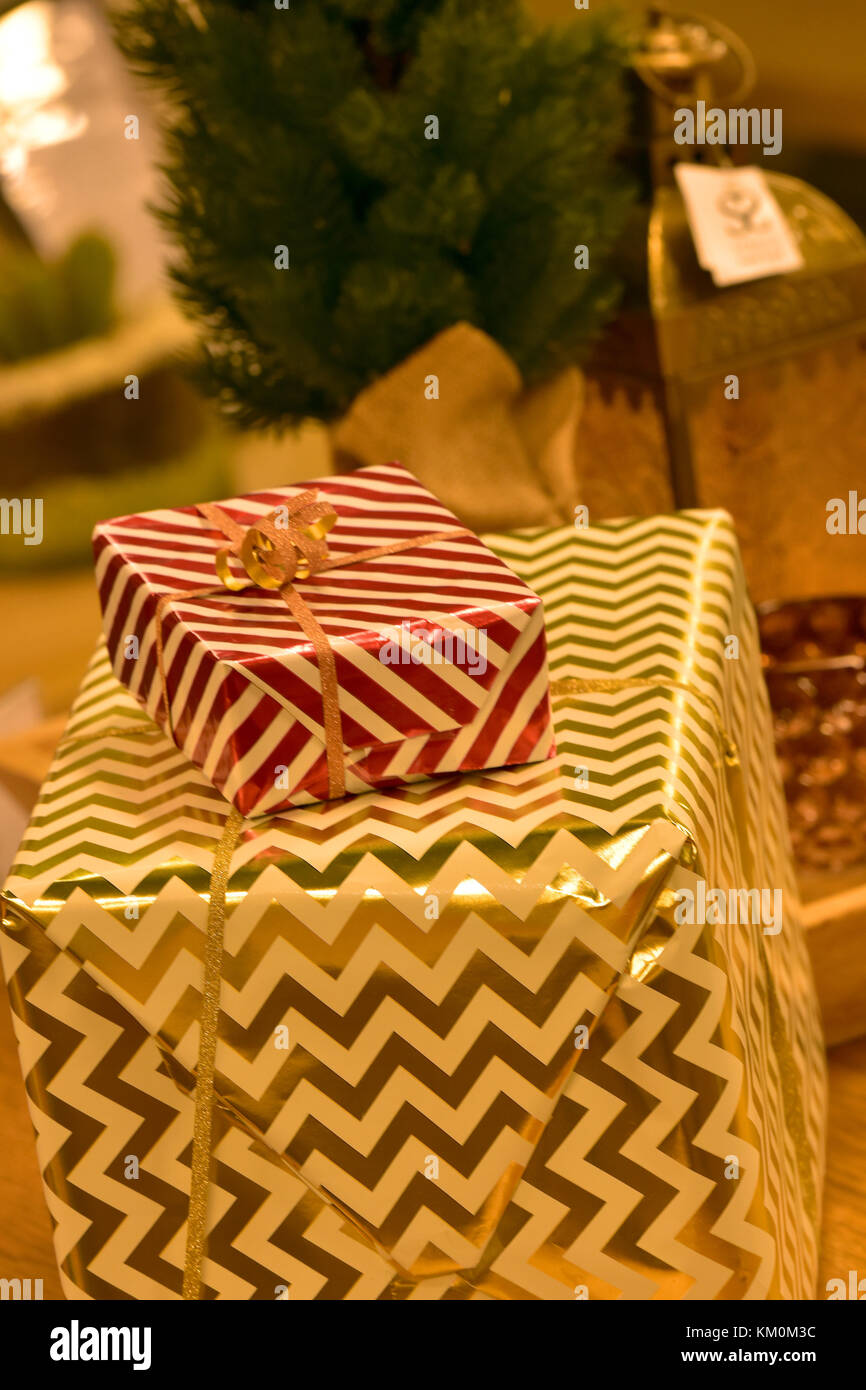 Christmas gifts or. Presents wrapped in quality shiny red and gold ...