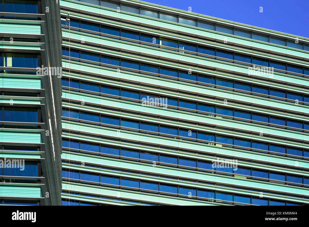 Windows of futuristic glass and metal skyscraper building reflecting ...