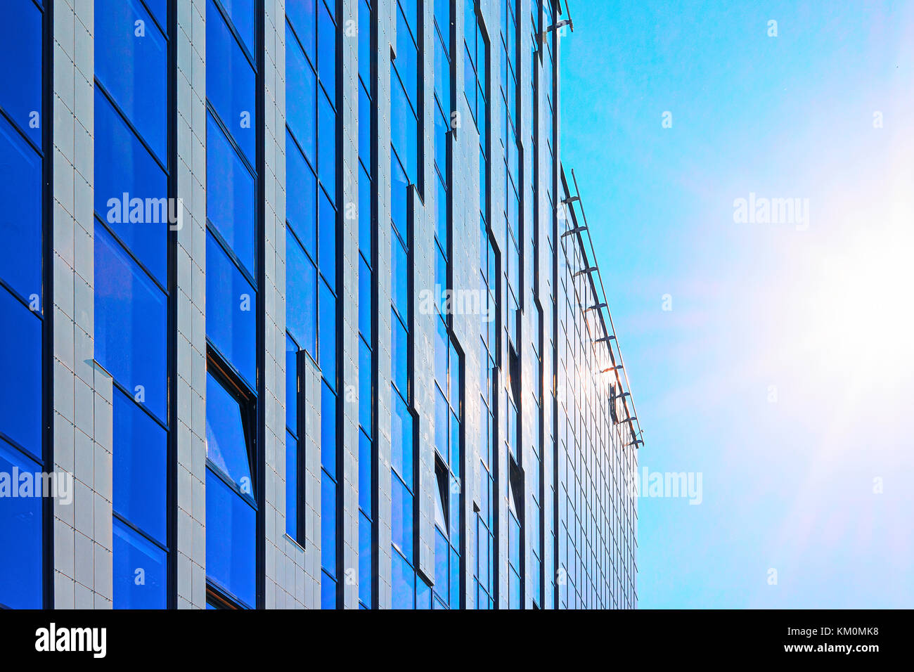 Windows of futuristic glass and steel skyscraper building reflecting ...