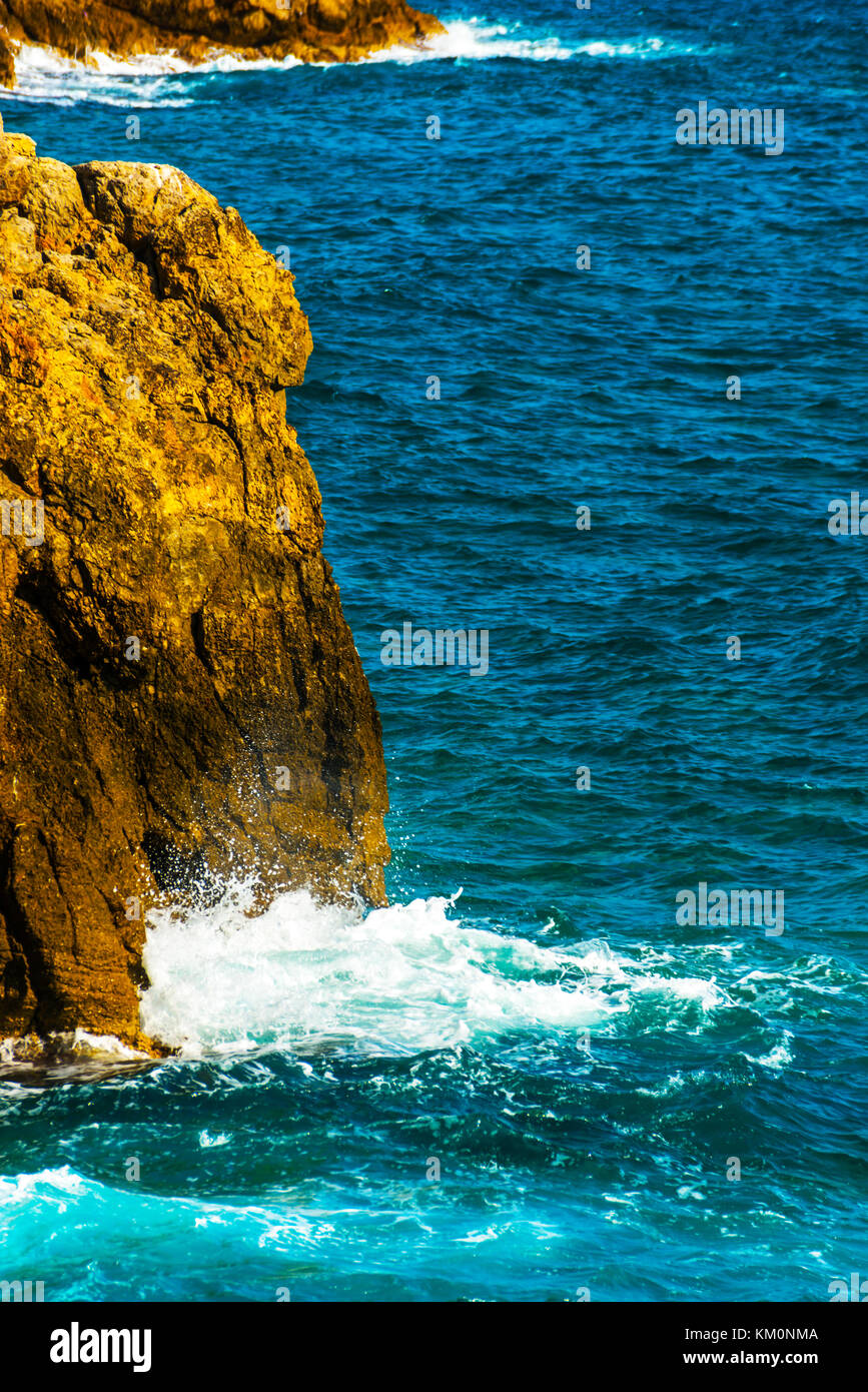 high cliff above the sea, summer sea background, many splashing waves ...