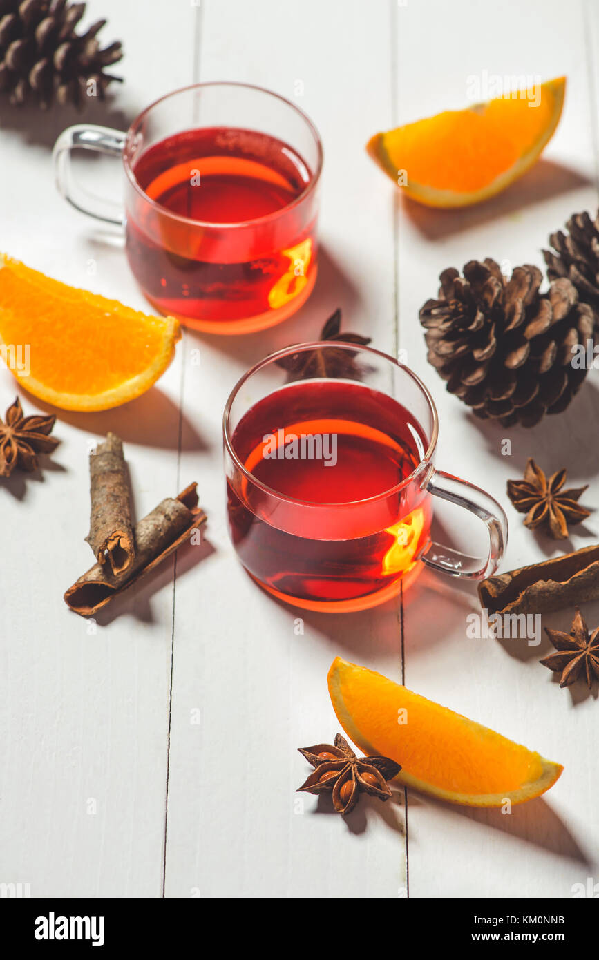 Christmas drink. Glass cup of tea with lemon and cinnamon on wood table ...