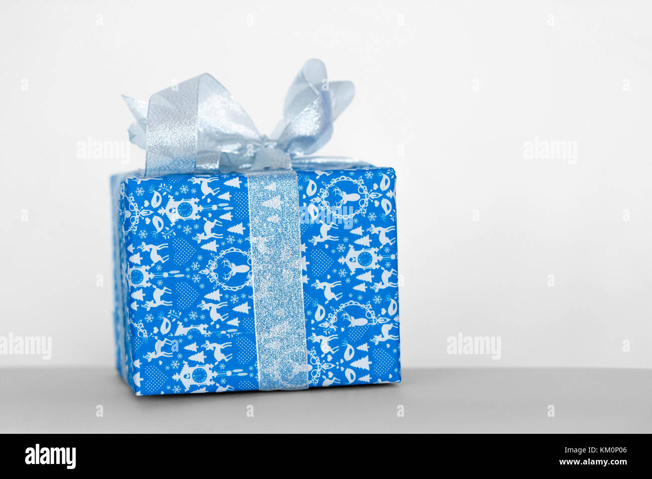 Blue gift box with ribbon on white background Stock Photo - Alamy