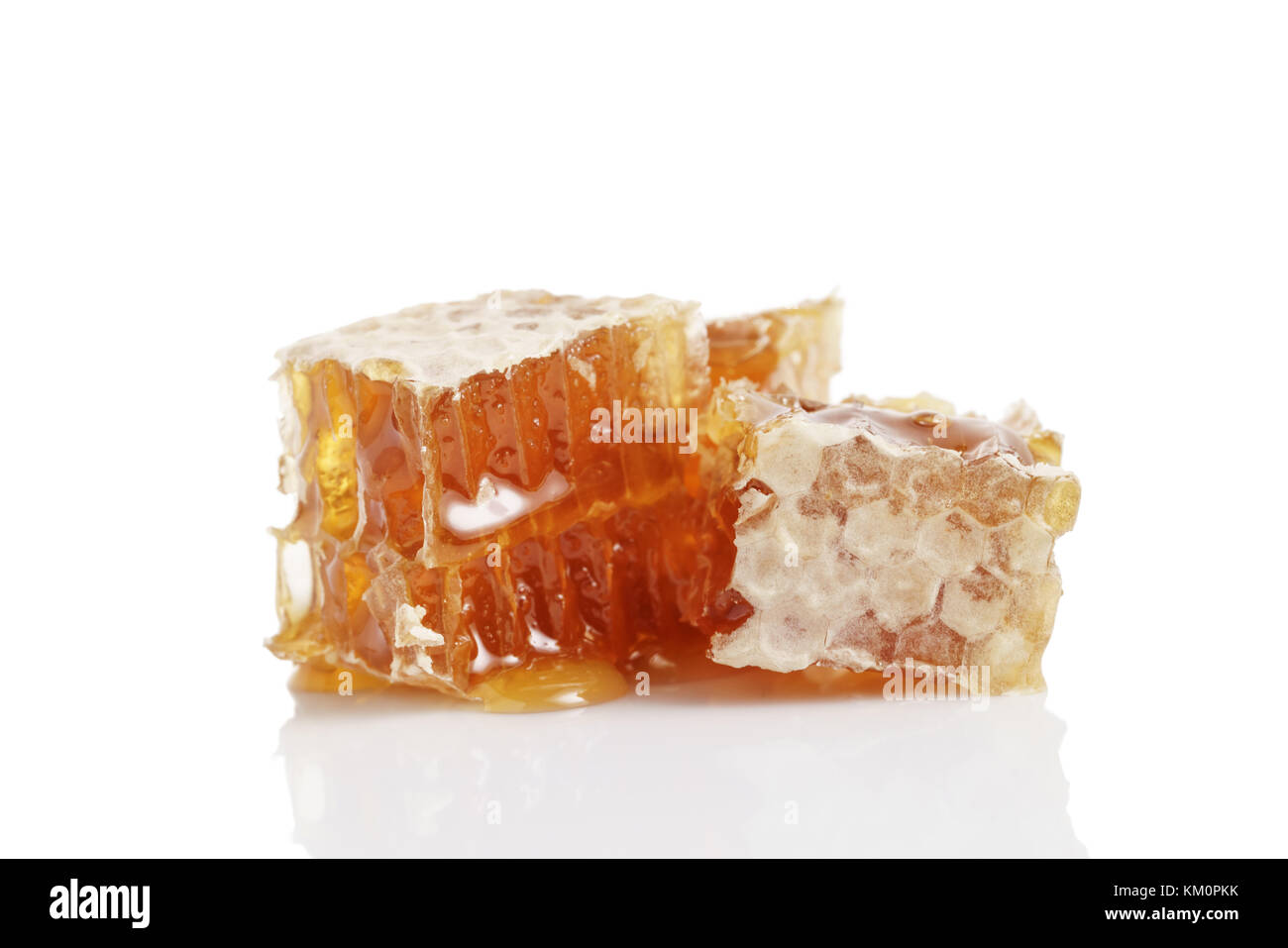 three pieces of honeycom isolated on white background Stock Photo - Alamy