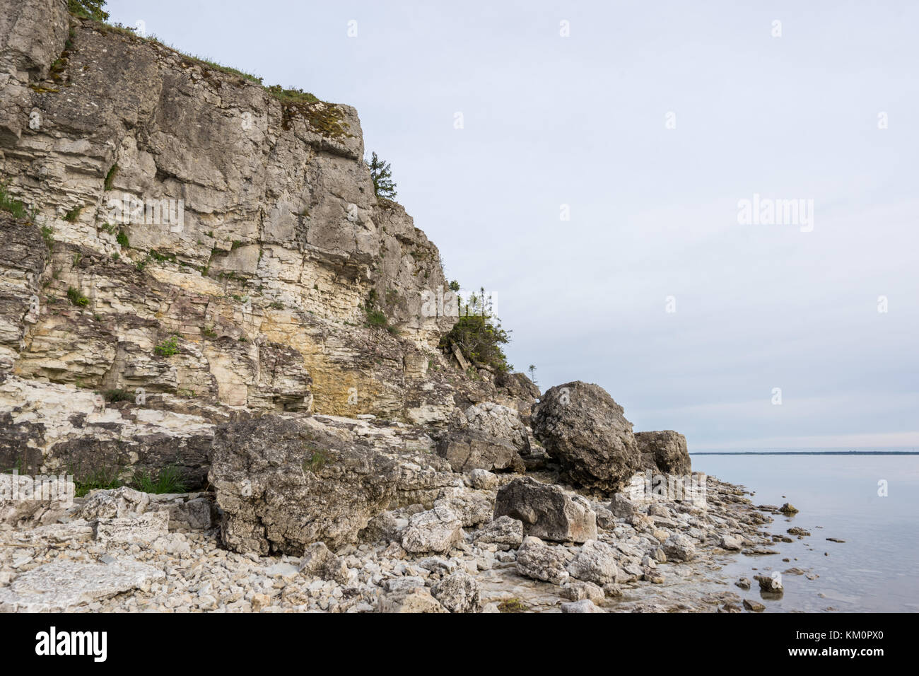 Sunset on the beach. Limestone cliff in the sea under blue sky and ...