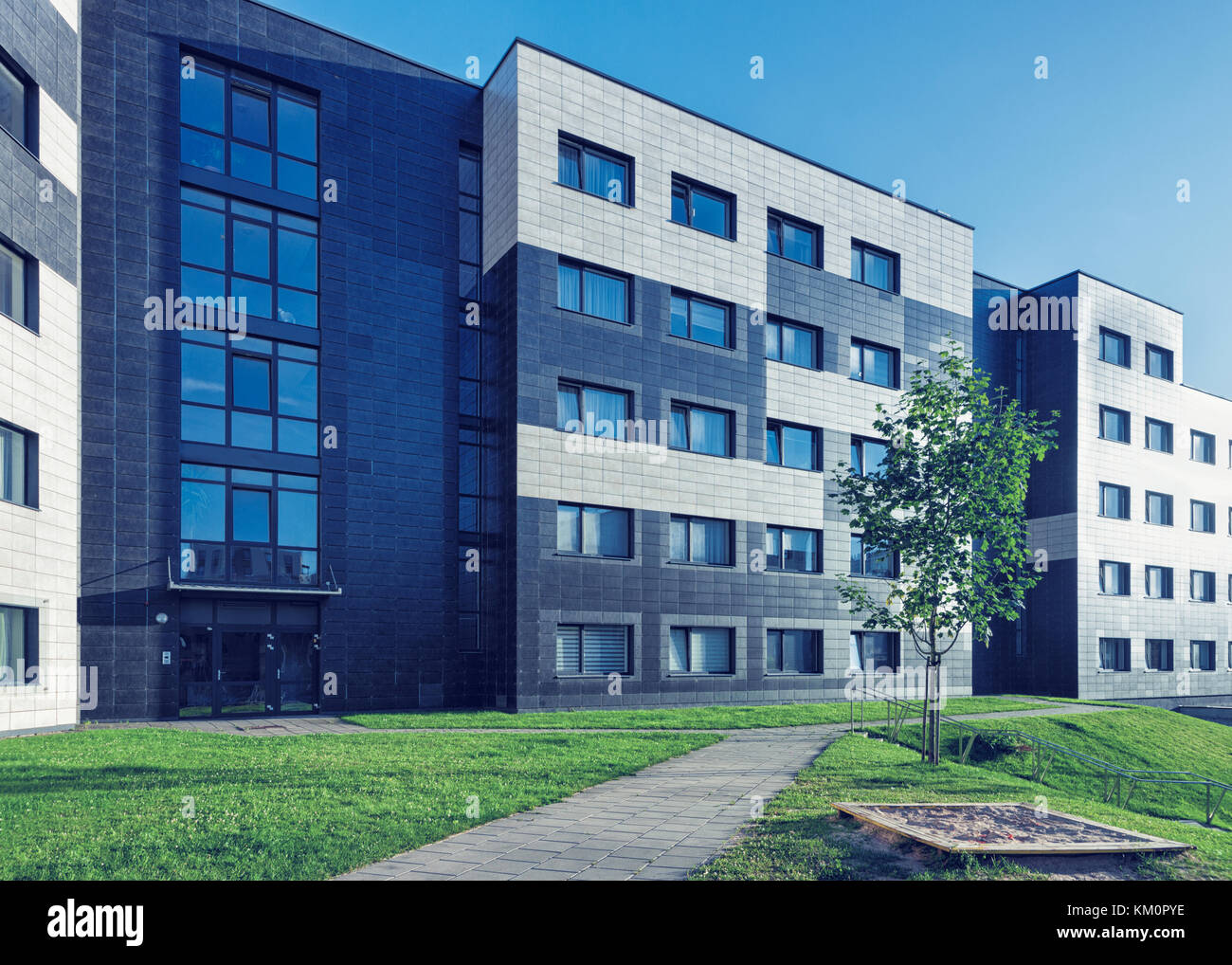Complex of modern residential building with children playground as ...