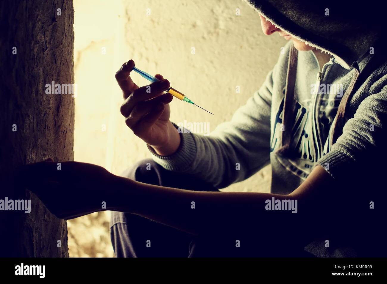 Drugs concept. Disease concept. Drug addict man with syringe using ...