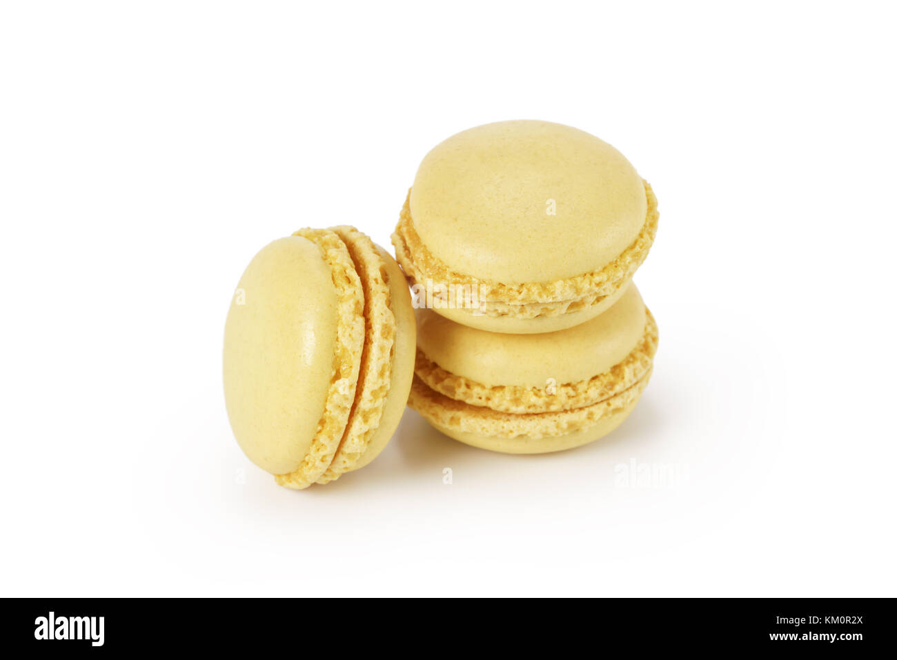 three yellow lemon macarons isolated on white background Stock Photo ...