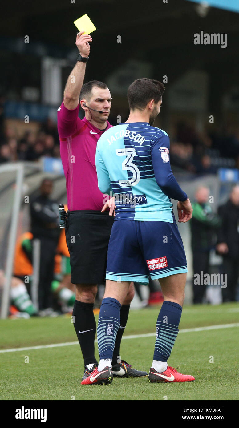 Wycombe Wanderers' Joe Jacobson is shown the yellow card during the ...