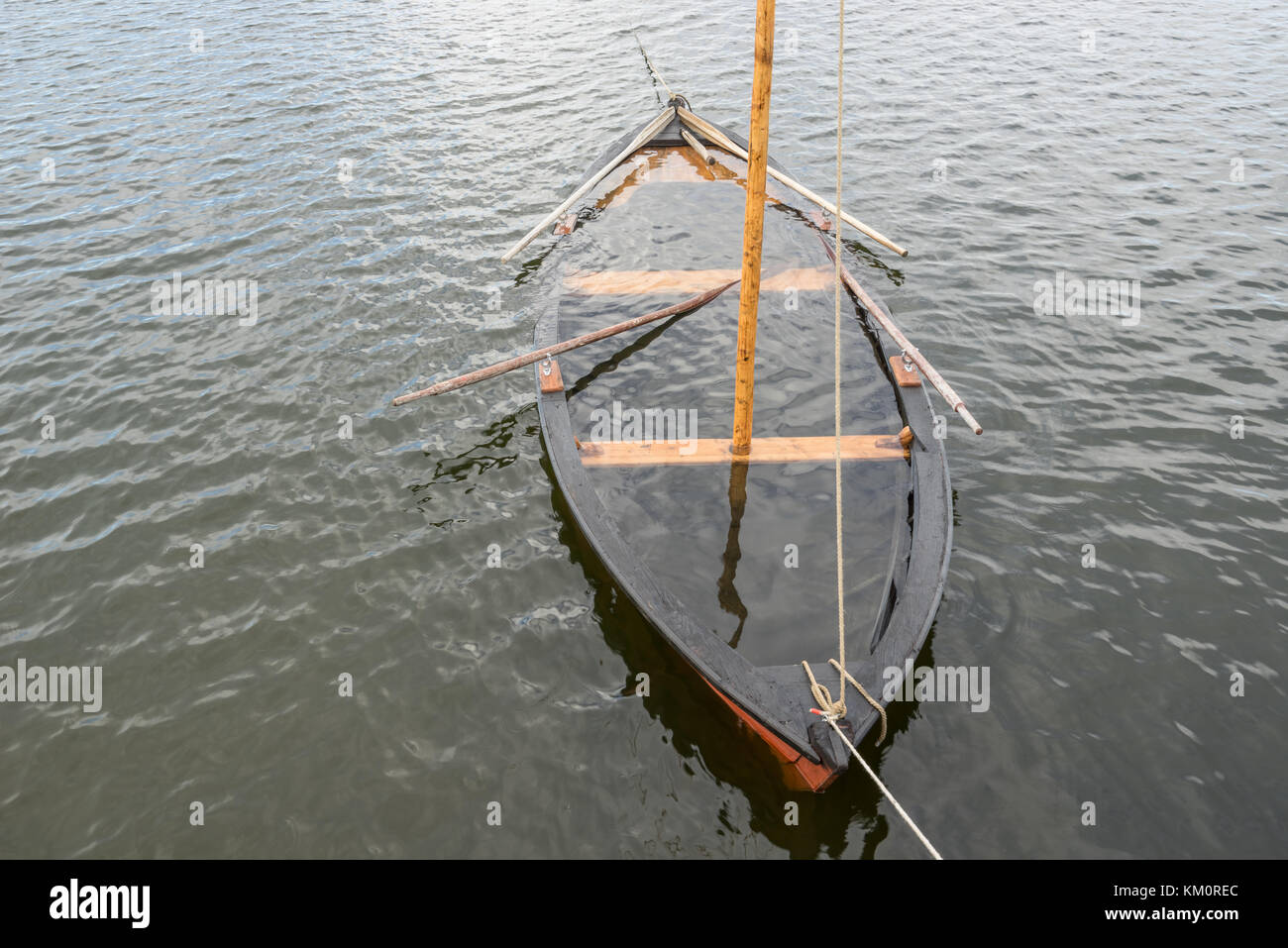 Wooden sailboat on the sea, water inside. Boat under water Stock Photo ...
