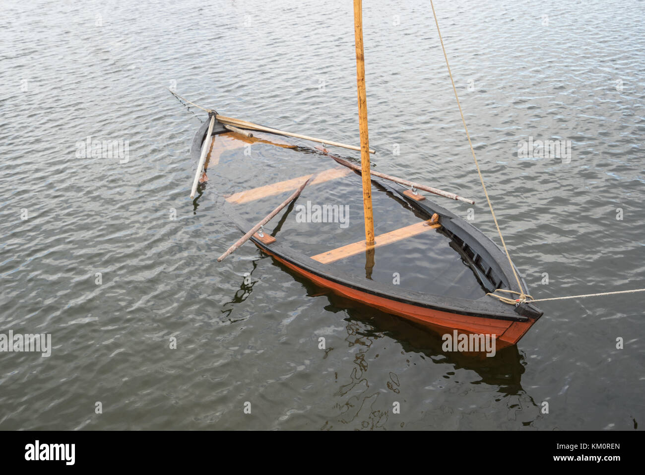 Wooden sailboat on the sea, water inside. Boat under water Stock Photo ...