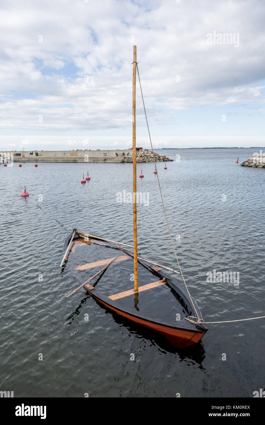 Wooden sailboat on the sea, water inside. Boat under water Stock Photo ...