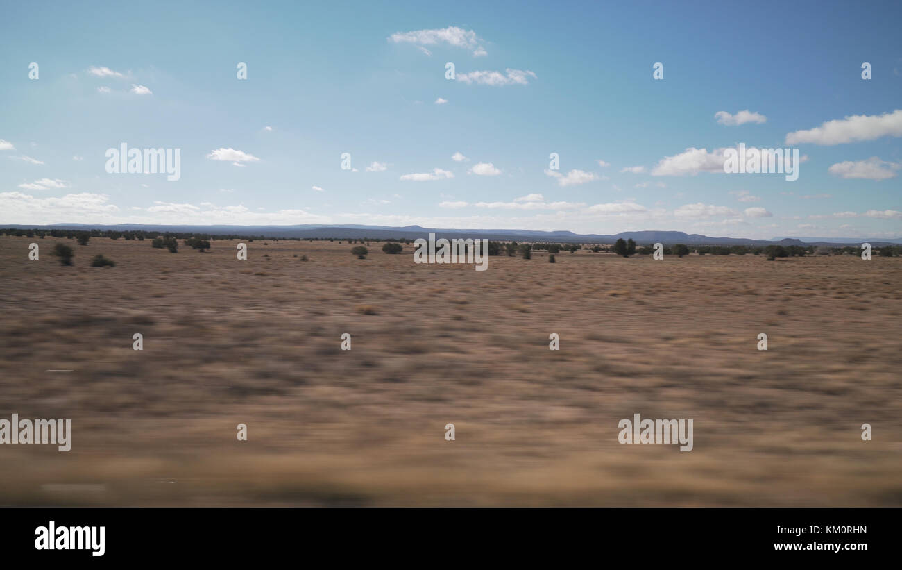 Driving plate side view moving through hills and fields with motion ...
