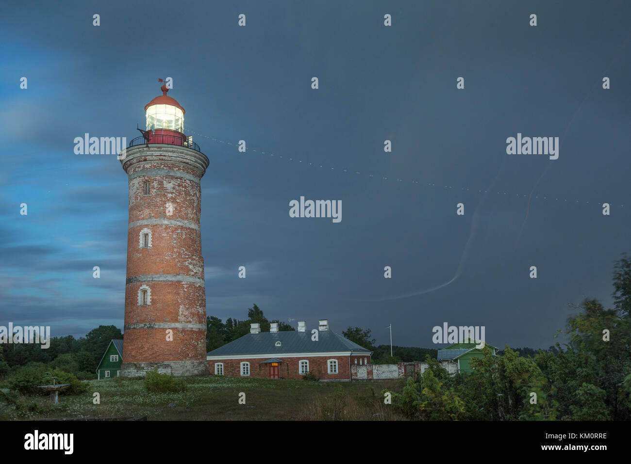 Lighthouse and house in the Baltic Sea. Shore, evening light, sunset ...