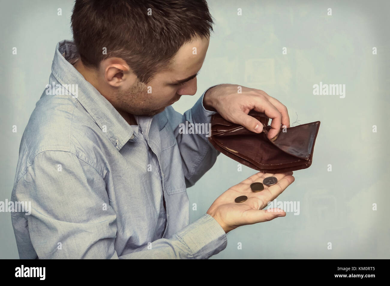 Coins and an empty wallet. poor man pulls out the last coins from her ...