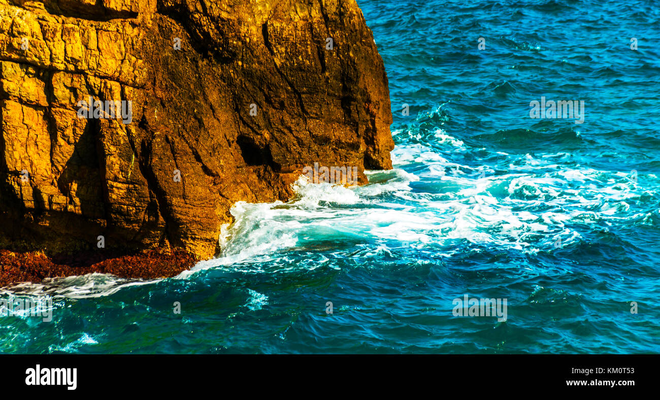 high cliff above the sea, summer sea background, many splashing waves ...