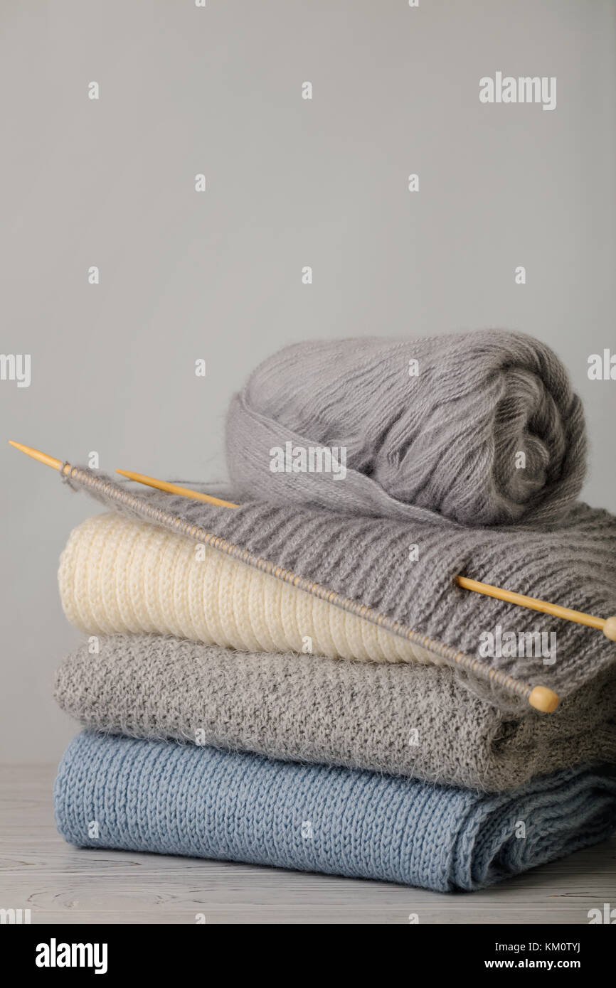 Handmade, knitting and woolen thread. Pile of knitted clothes blue ...