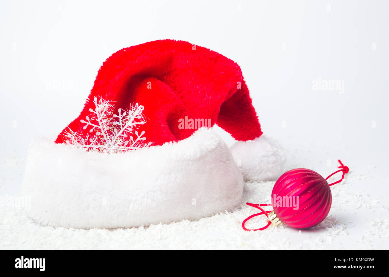 Big Santa hat and red Christmas decorations on white background Stock ...