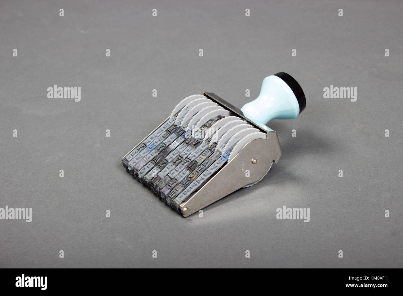 blue handled rubber stamp with ink and numbers and letters Stock Photo ...