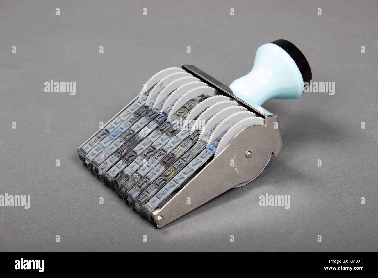 blue handled rubber stamp with ink and numbers and letters Stock Photo ...