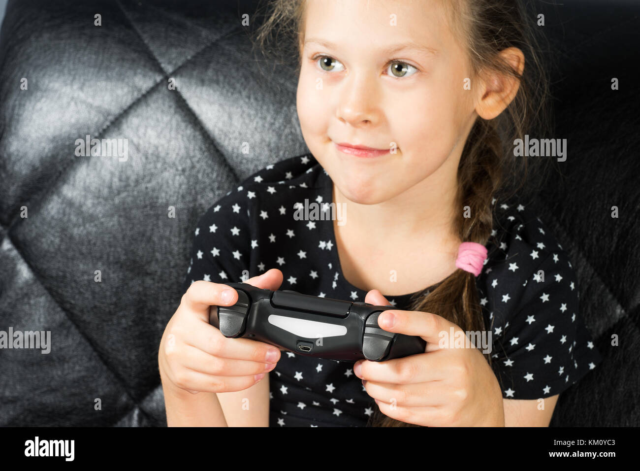 Child playing video games and holds joystick or controller Stock Photo ...