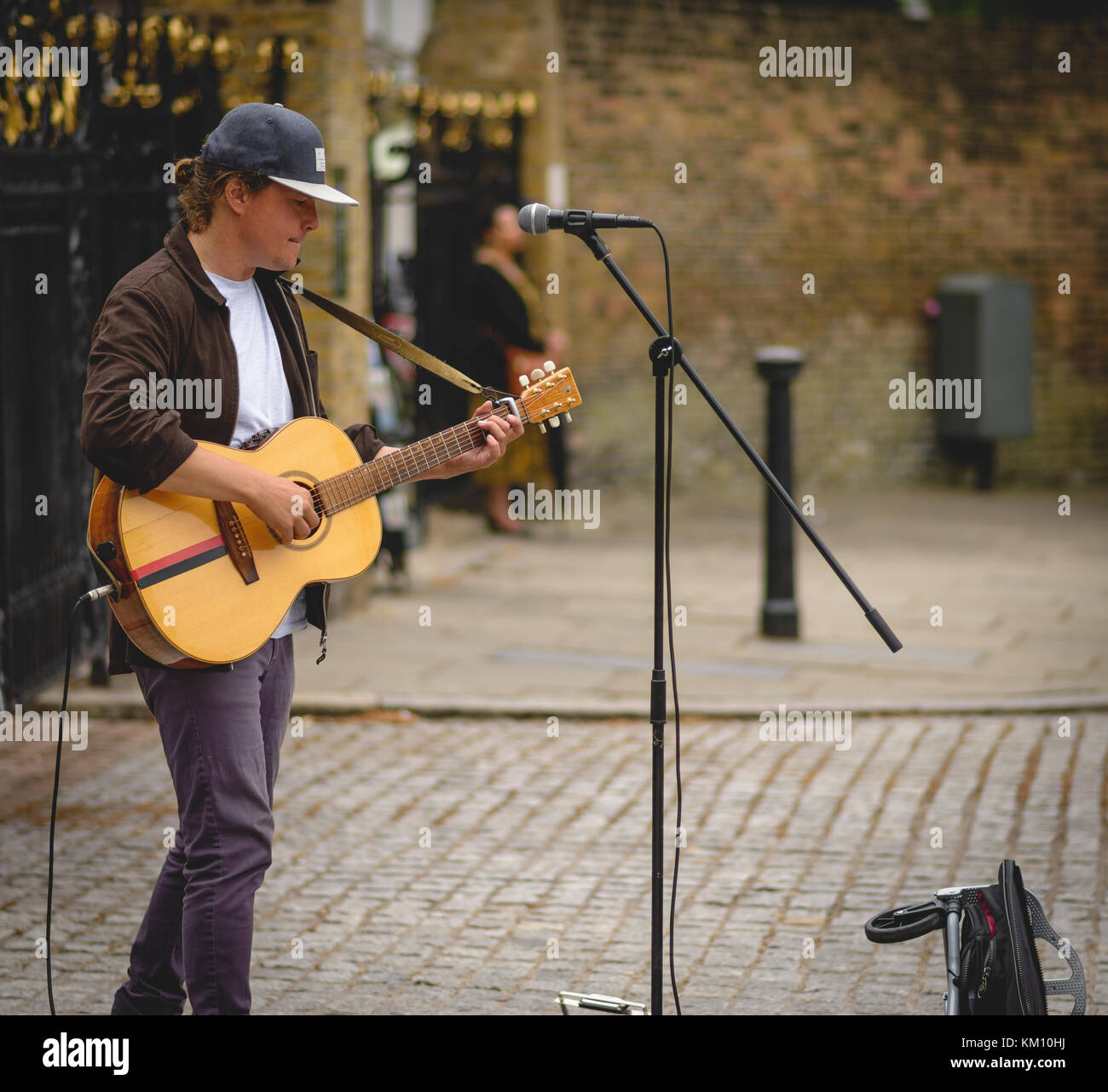 Street musician in Greenwich Park in London (UK). July 2017. Square ...