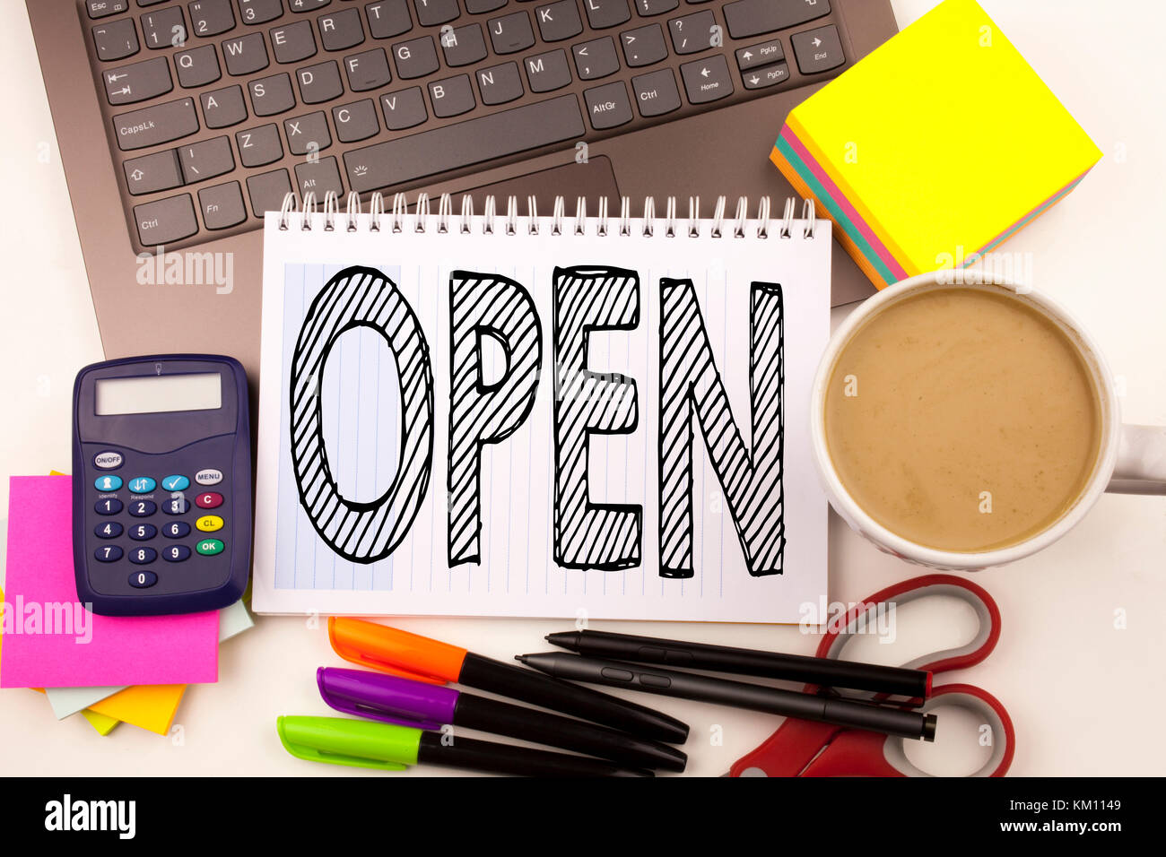 Word writing Open in the office with laptop, marker, pen, stationery ...