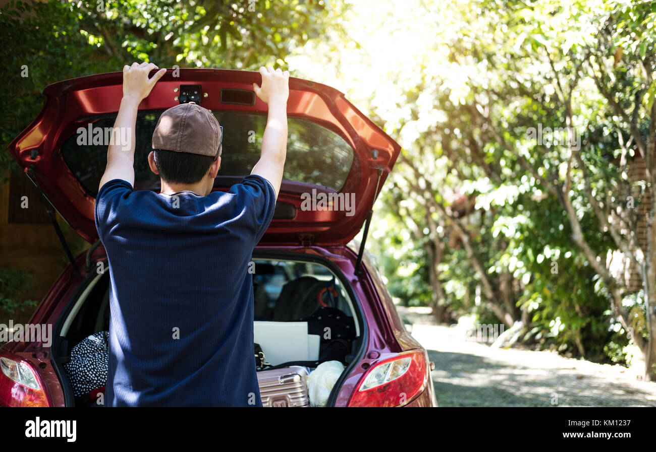 Traveling in summer, a man opened car backdoor for luggage Stock Photo ...