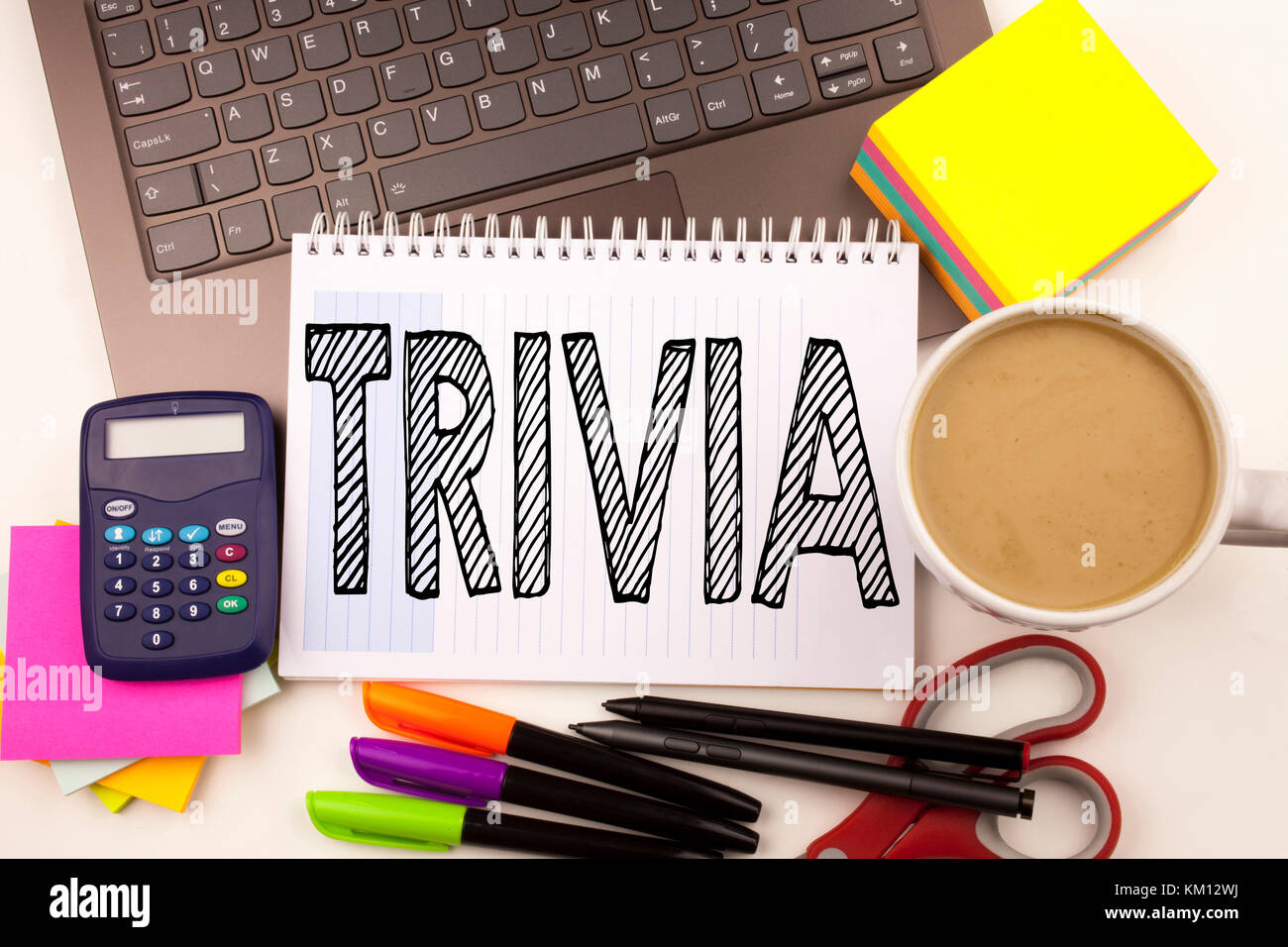 Word writing Trivia in the office with laptop, marker, pen, stationery ...