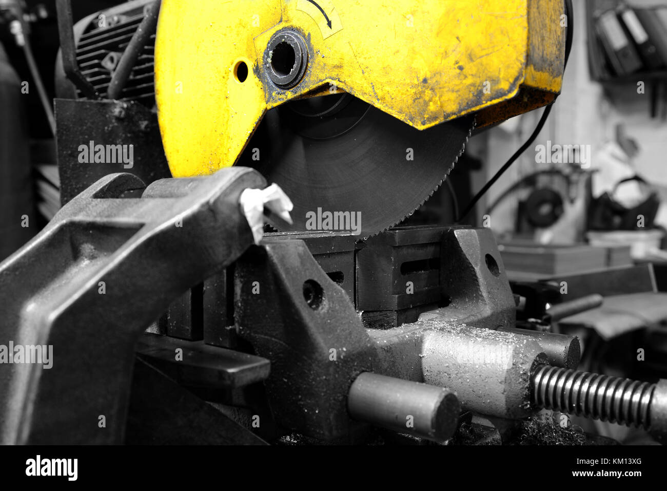 Industrial circular saw machine in a workshop with selective colour ...