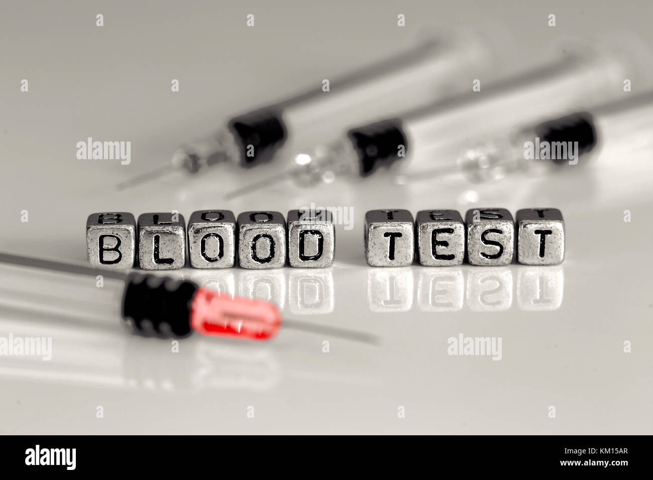 Syringes and blood with blood test on beads Stock Photo - Alamy