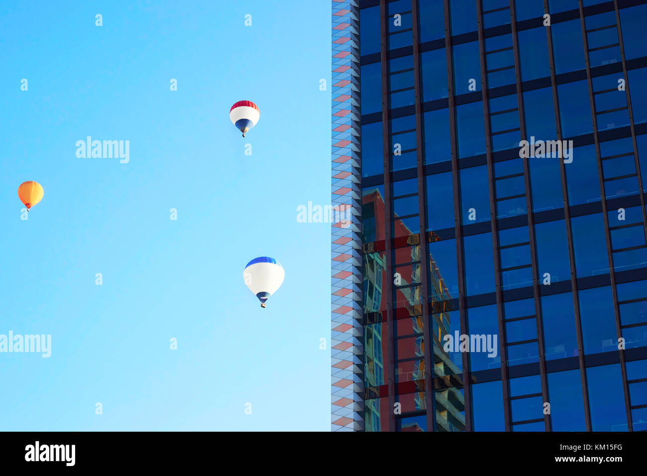 Air balloons and architecture of modern metal and glass skyscraper ...