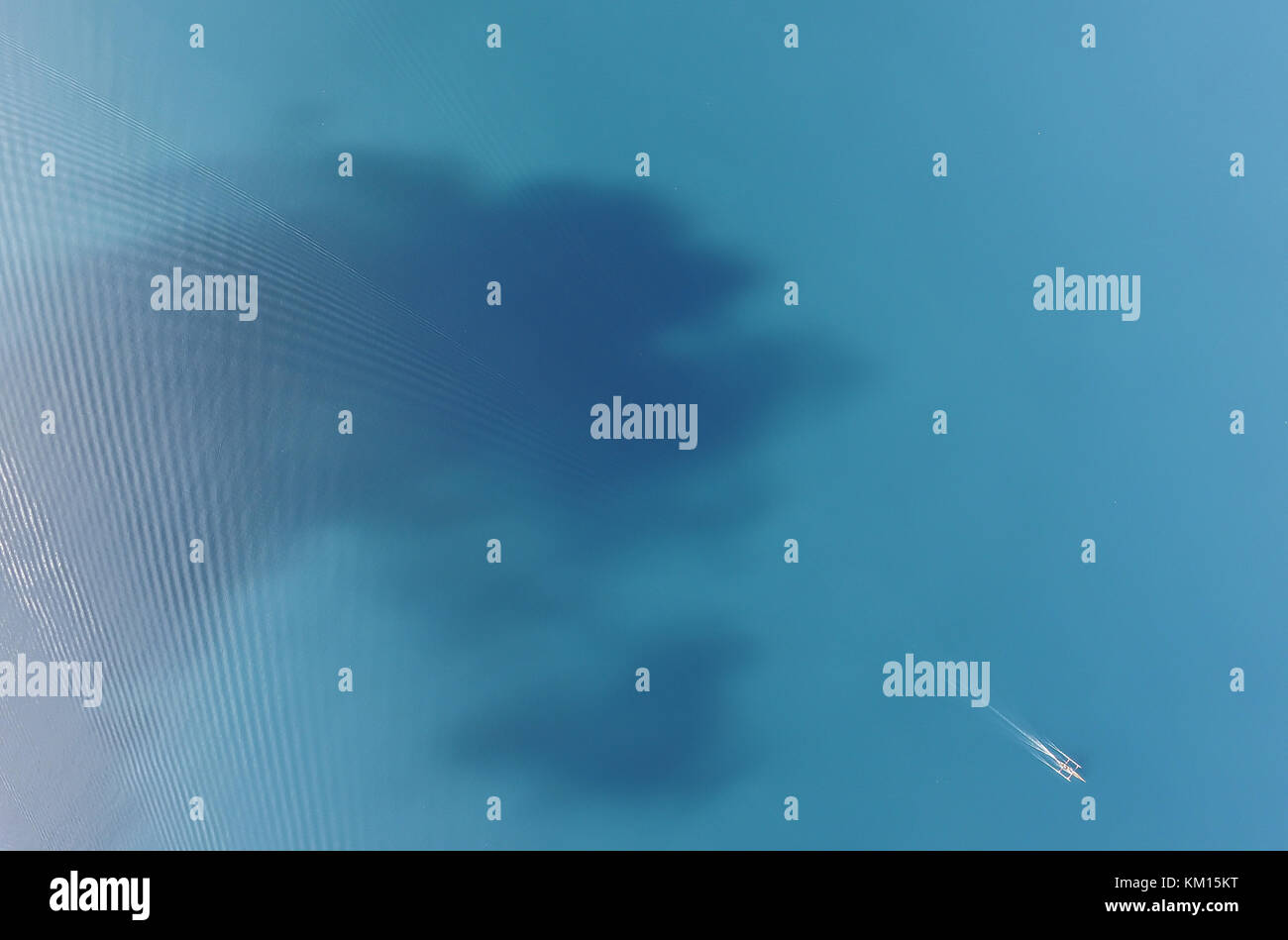 Traditional boat passing by in the middle of Matano Lake (the deepest ...