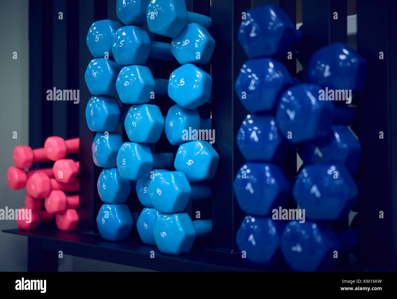 colored dumbbells on the pyramid in the gym Stock Photo - Alamy