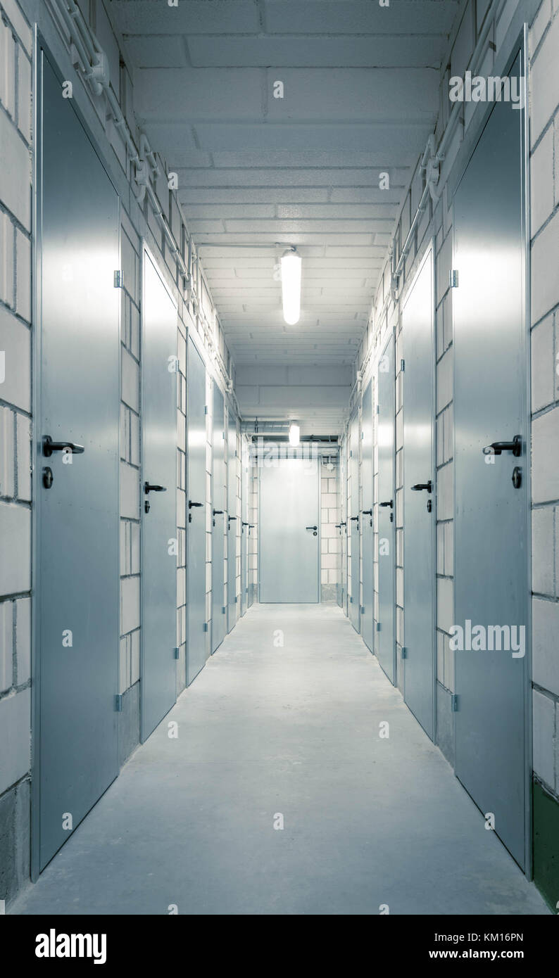 a long corridor in the basement with metal doors Stock Photo - Alamy
