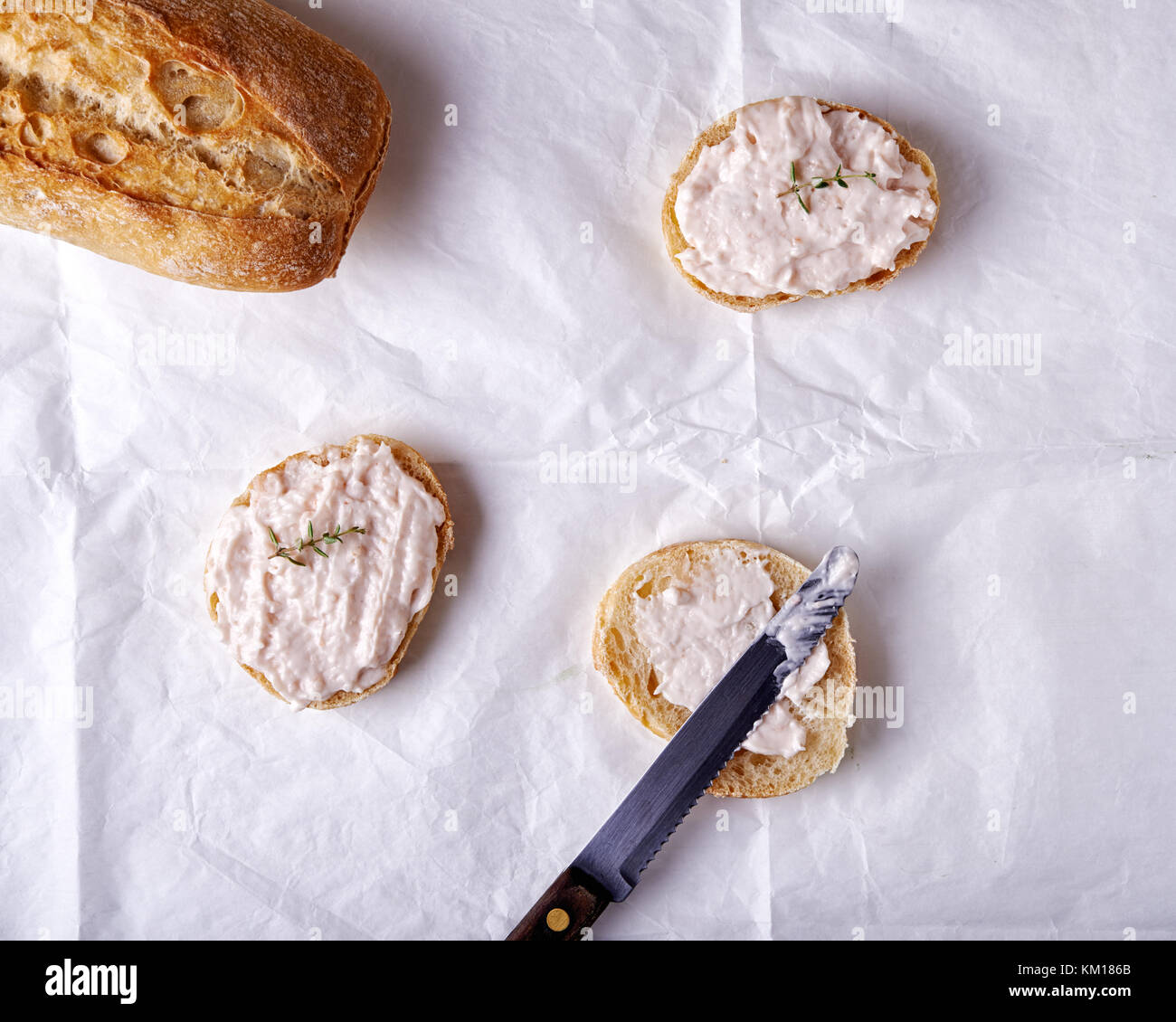 bread with fish spread and knife on white background. top view Stock ...